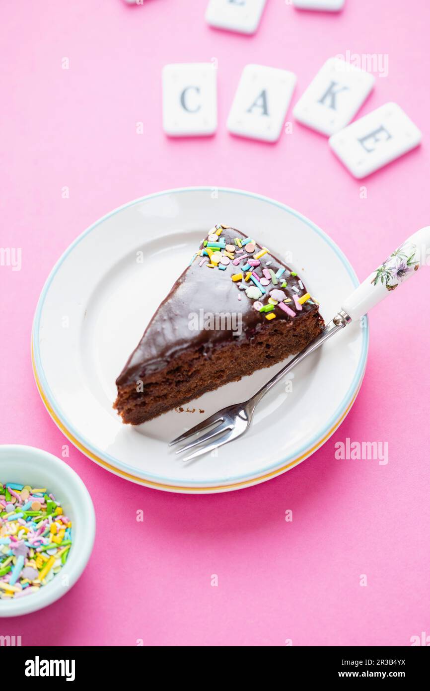 A slice of crazy cake (chocolate cake with colourful sprinkles Stock ...