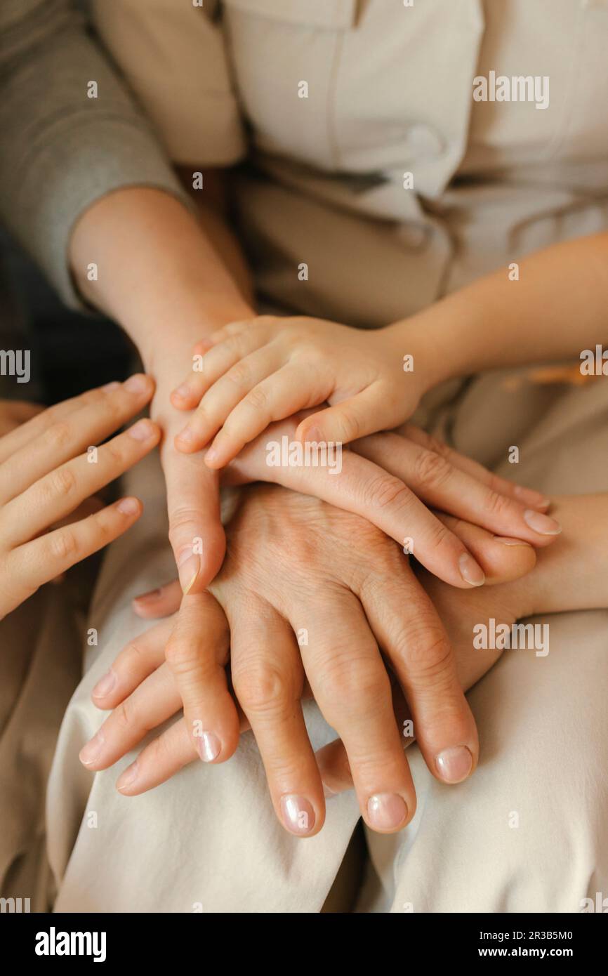 Family stacking hands at home Stock Photo - Alamy
