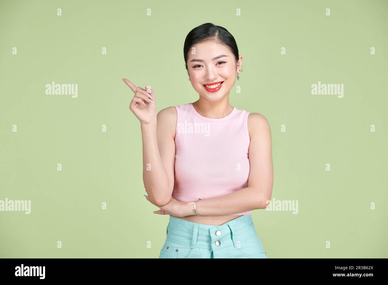 Portrait of Asian beautiful young woman pointing one hand with finger ...