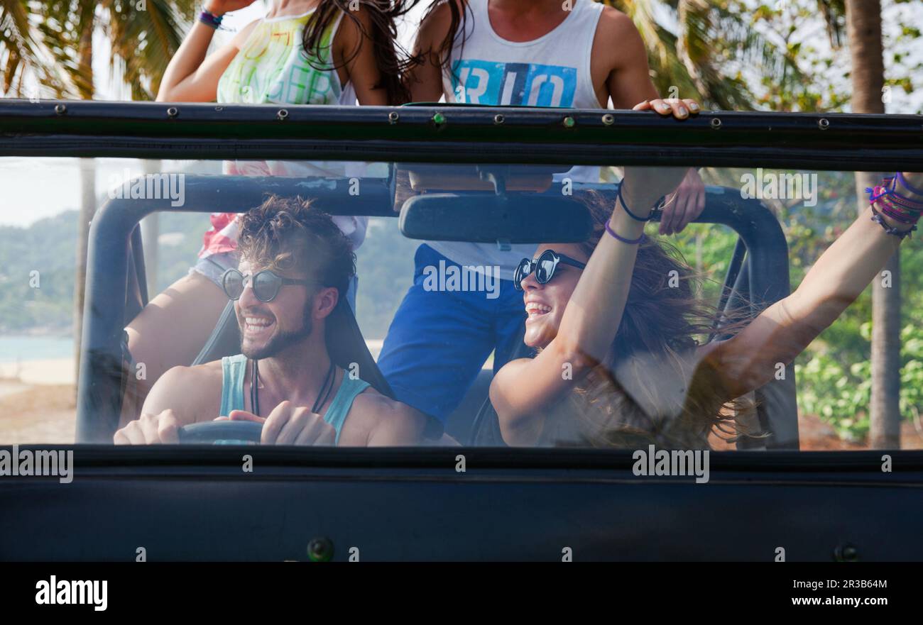 Friends enjoying off-road vehicle trip at beach Stock Photo - Alamy