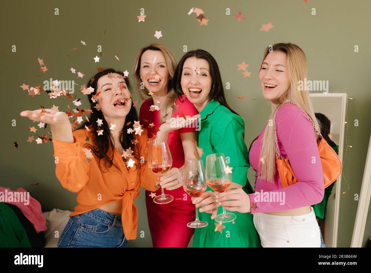 Happy women celebrating with each other at house party Stock Photo - Alamy