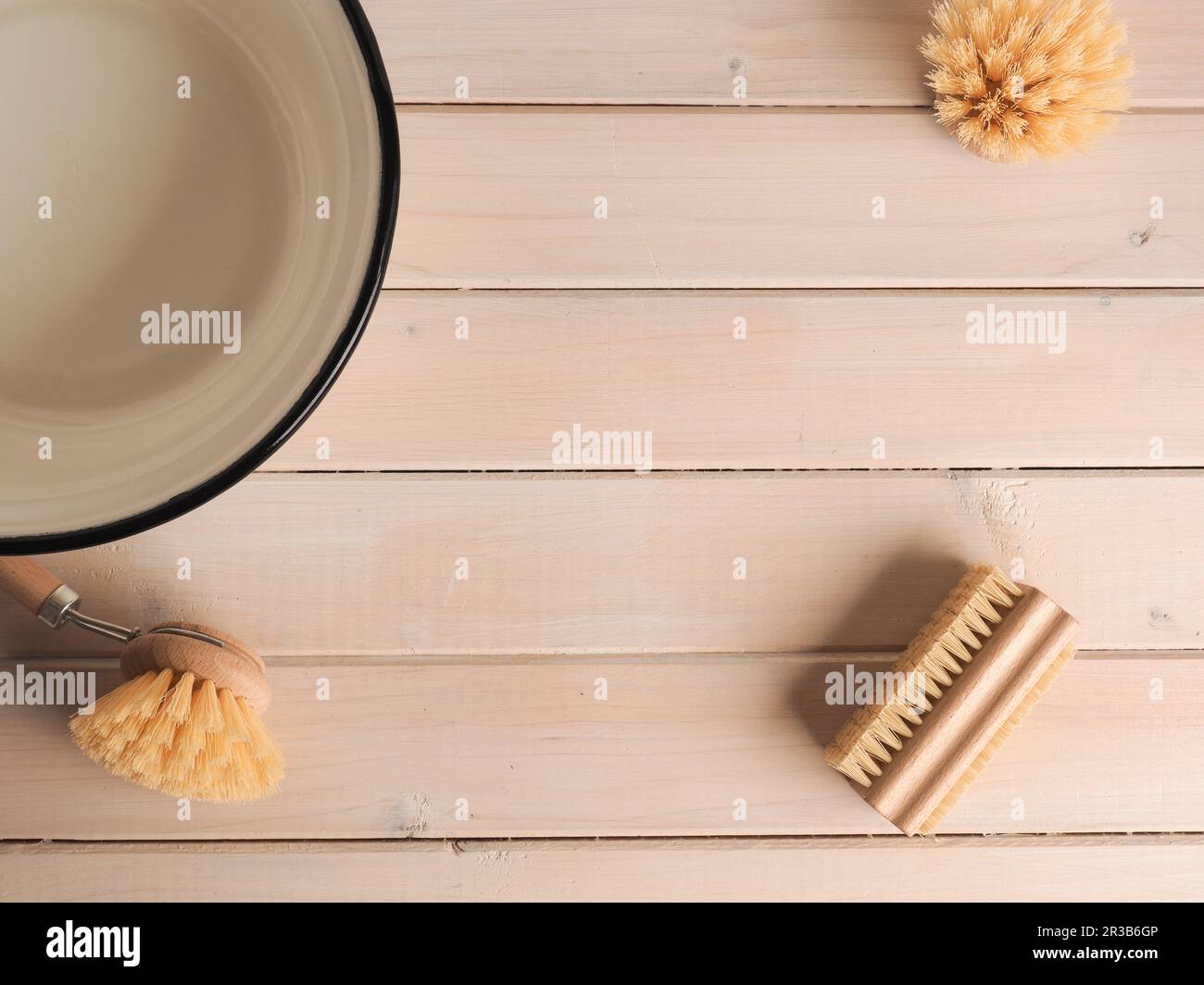 Plastic-free dishwashing utensils on a wooden table, alternative ...