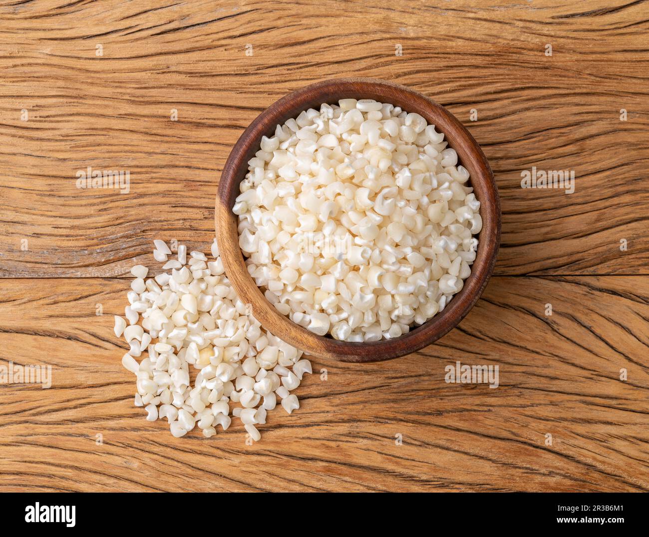 Dried canjica, hominy or white corn on a bowl over wooden table Stock ...