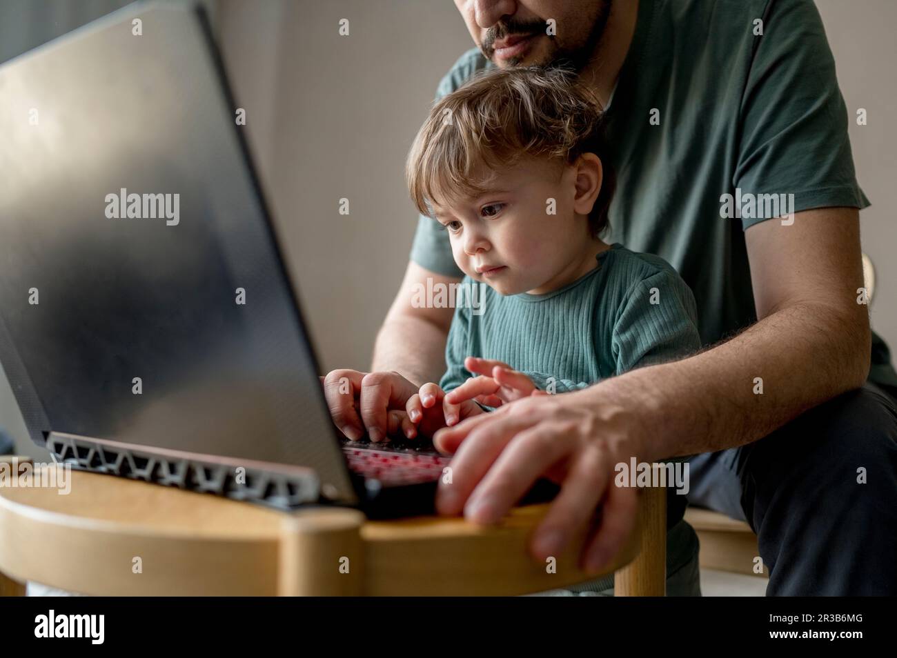 Father and son using laptop at home Stock Photo - Alamy