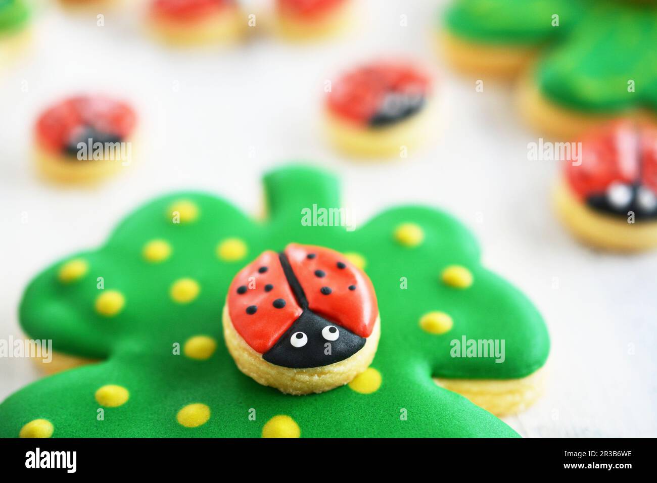 Ladybirds on lucky clover biscuits Stock Photo - Alamy