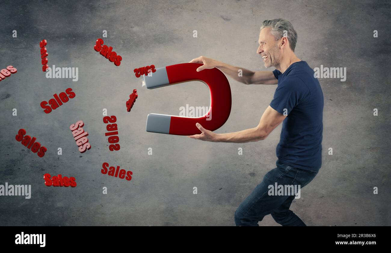 Happy man with a big magnet attracting sales, abundance or wealth ...