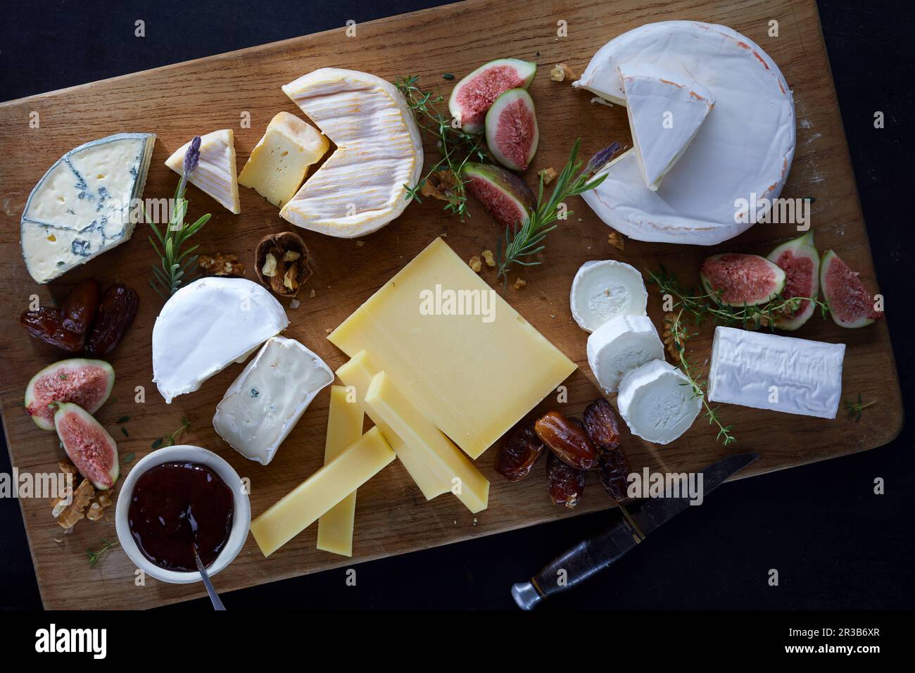 Cheese platter with figs, dates and walnuts Stock Photo - Alamy