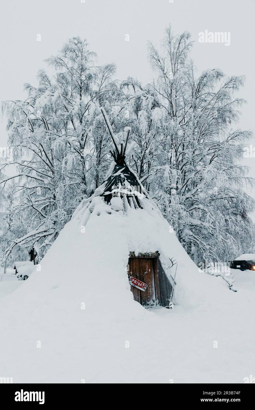 Snow-covered teepee in front of frozen trees Stock Photo - Alamy