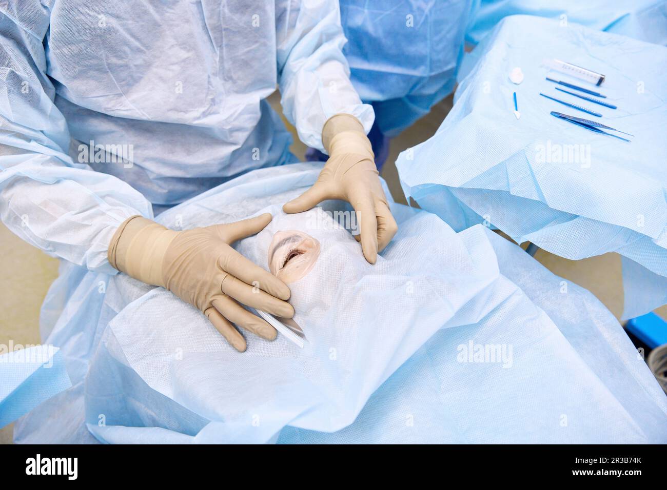 Ophthalmologist examining patient's eye in operating room Stock Photo ...