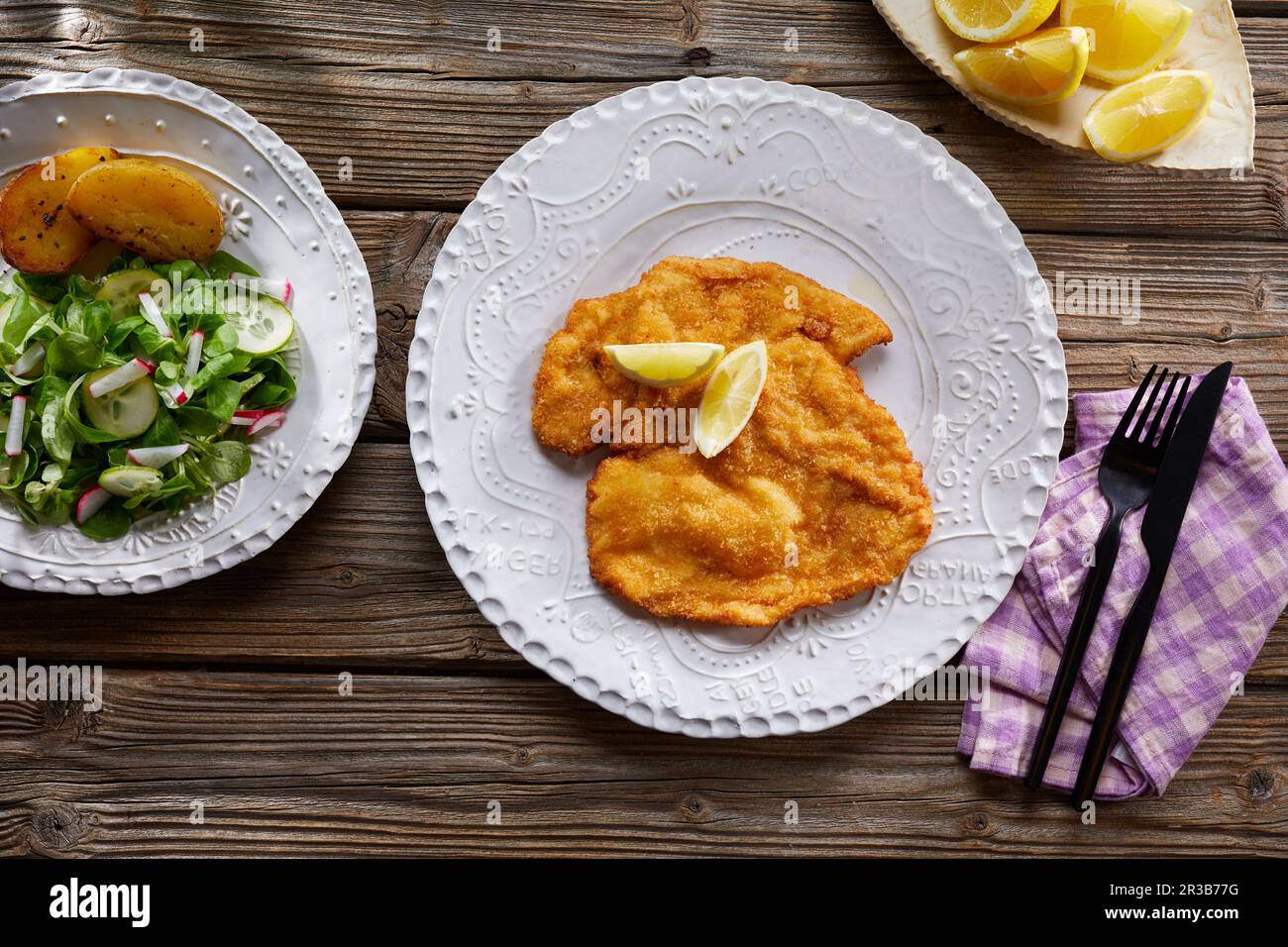 Wiener Schnitzel (breaded veal escalope) with salad Stock Photo - Alamy