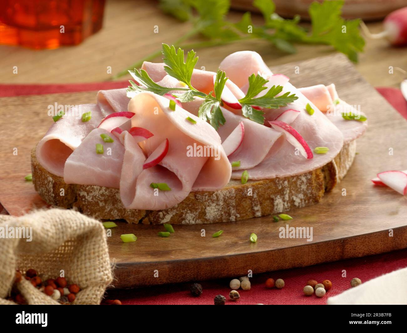 Hearty country bread with cooked ham and parsley Stock Photo - Alamy