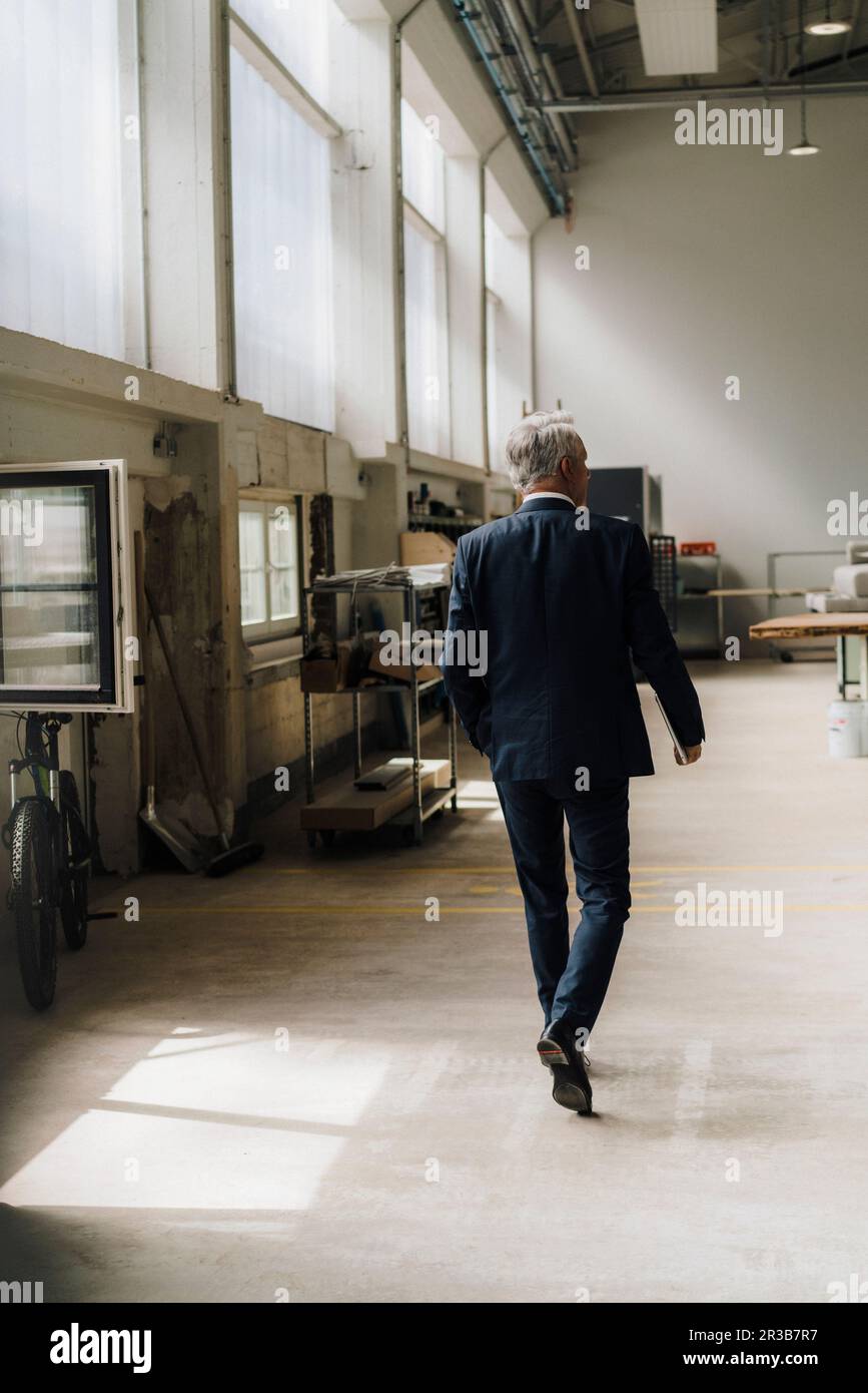 Businessman walking factory workshop hi-res stock photography and ...