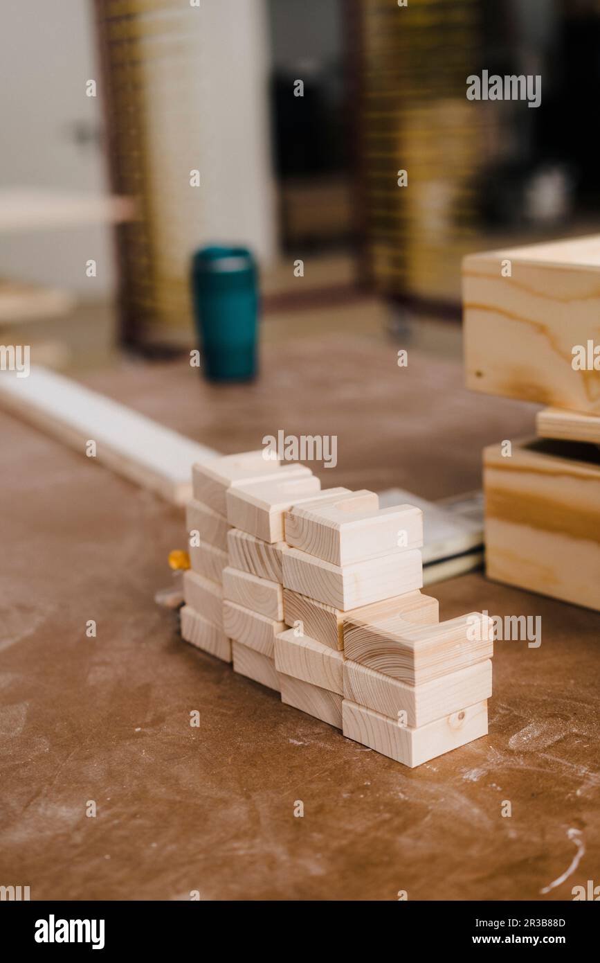 Wood blocks stacked on workbench in carpentry factory Stock Photo - Alamy