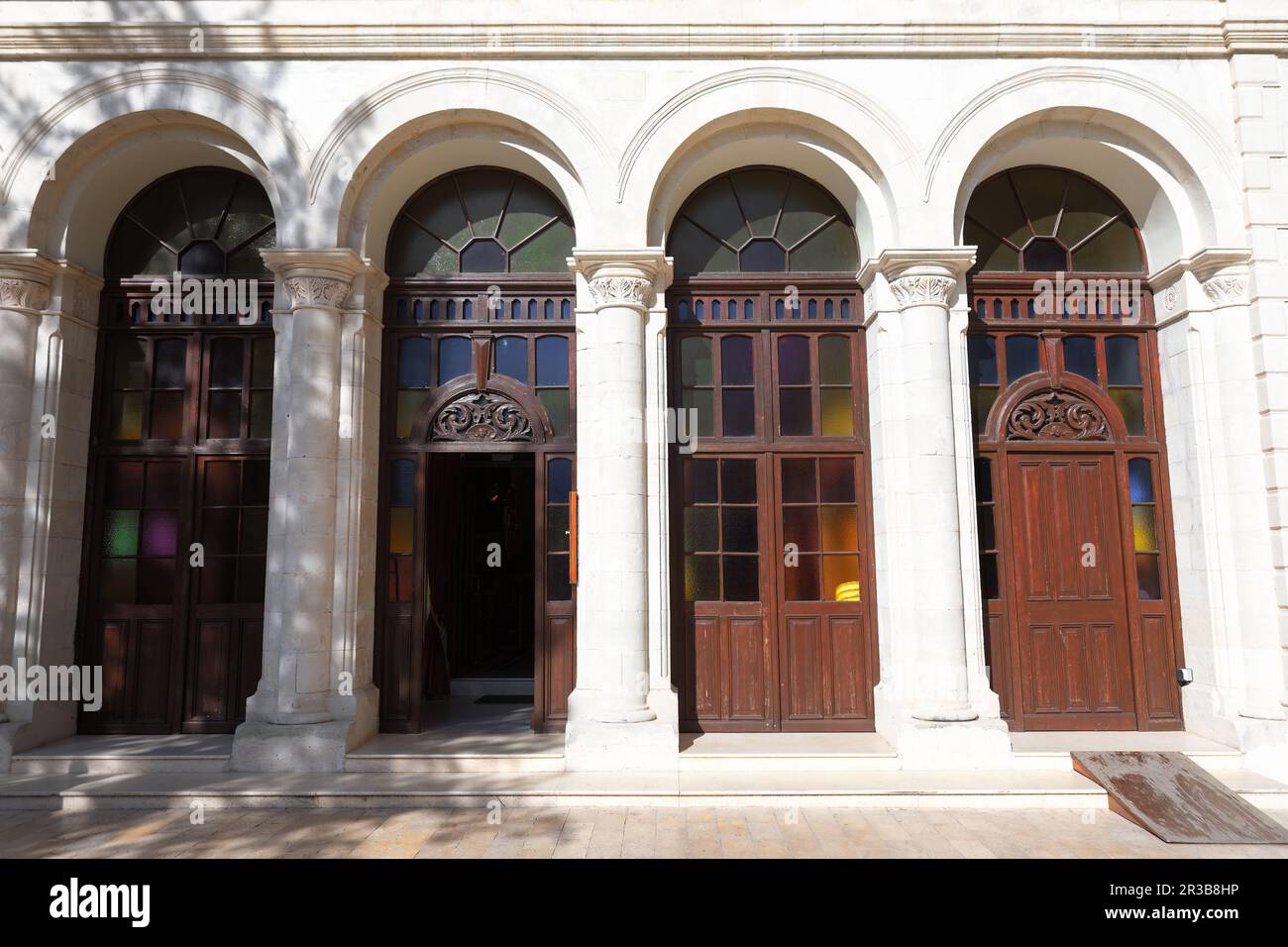 Arch door entrance in cathedral . Columns and wooden gates of church ...
