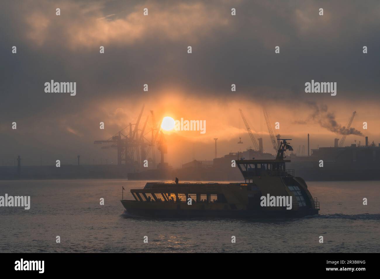 Germany, Hamburg, Sun rising over harbor ferry Stock Photo - Alamy