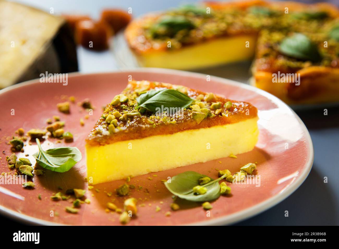 Cheesecake with quince jelly and pistachios Stock Photo - Alamy