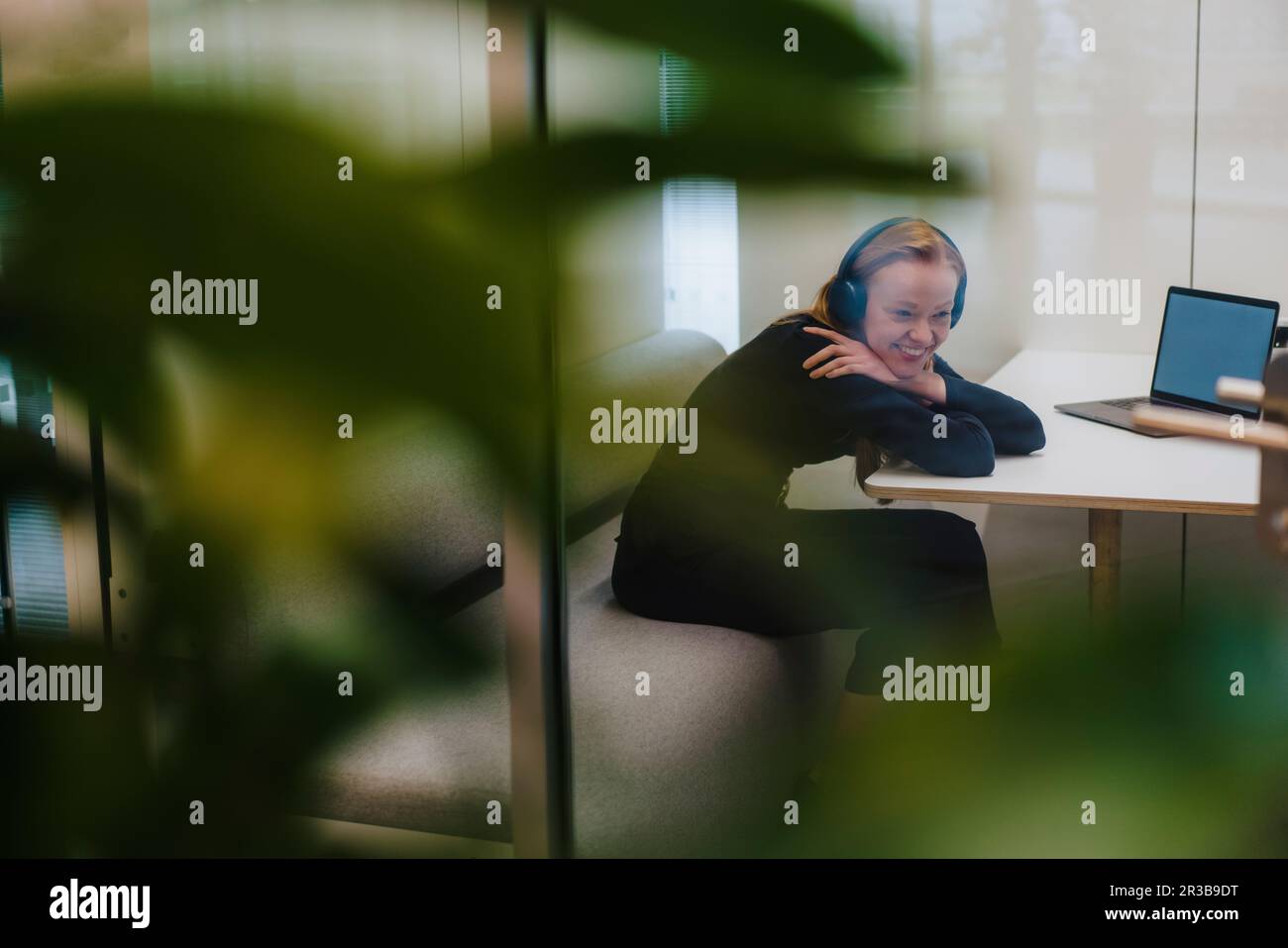Smiling businesswoman sitting in office cubicle Stock Photo - Alamy