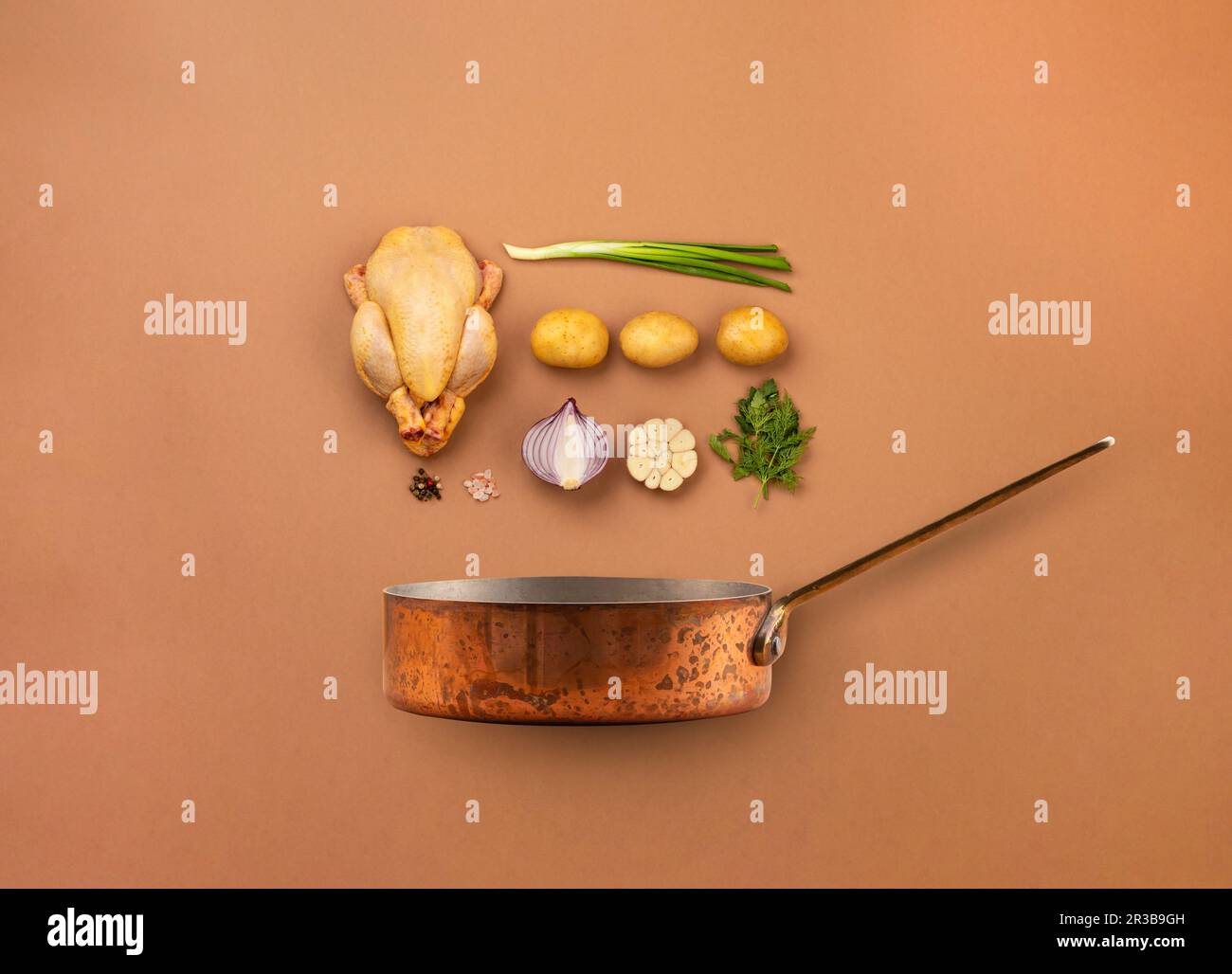 Set of raw ingredients arranged for cooking chicken soup or stew in ...