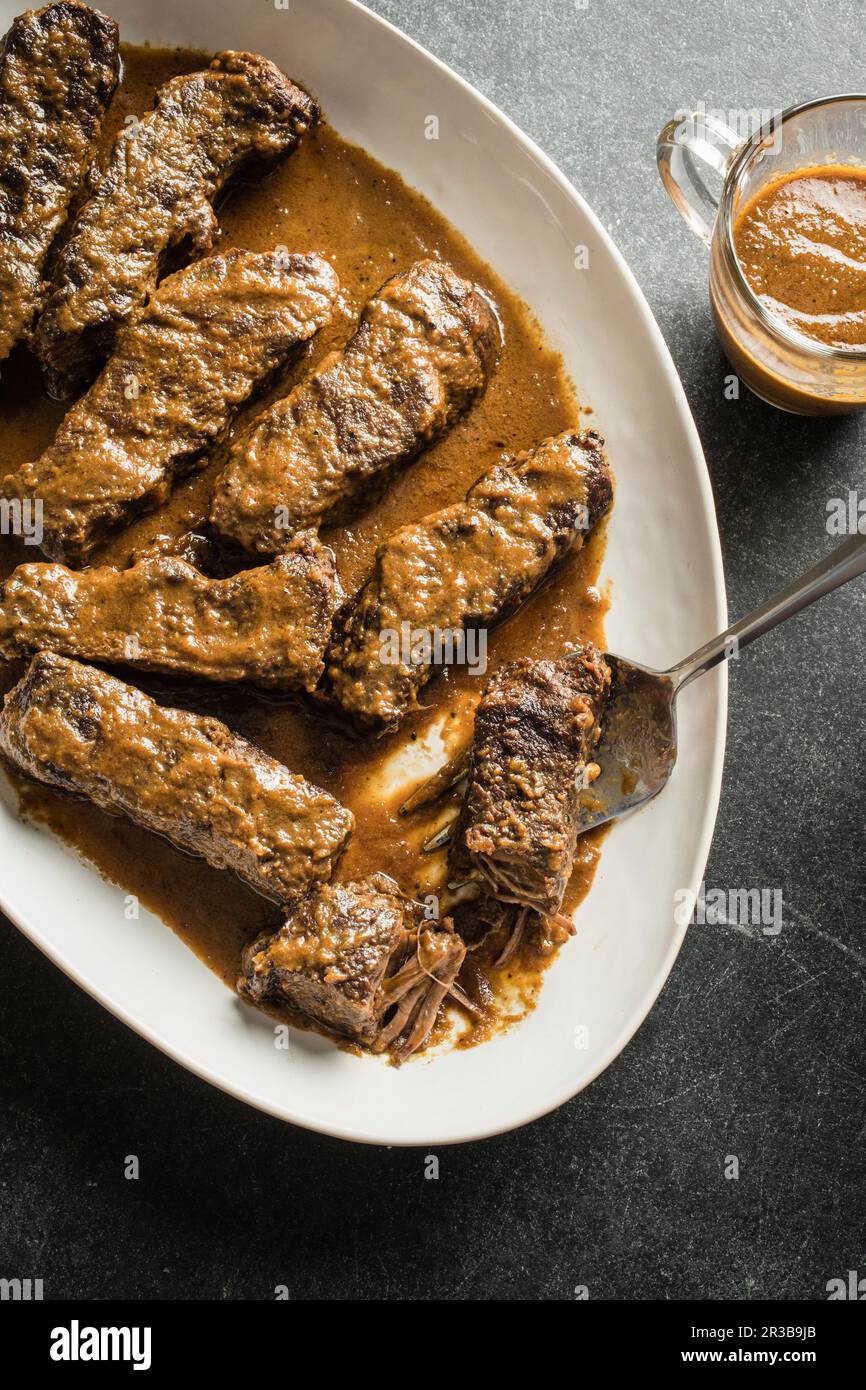 Mustard beer braised short ribs Stock Photo - Alamy