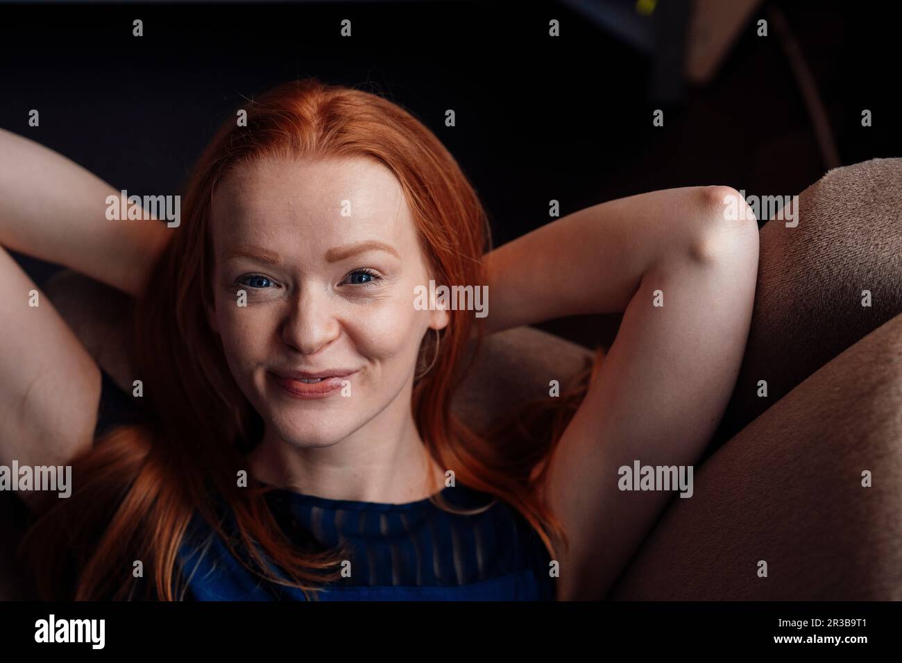 Woman lying arms behind head hi-res stock photography and images - Alamy