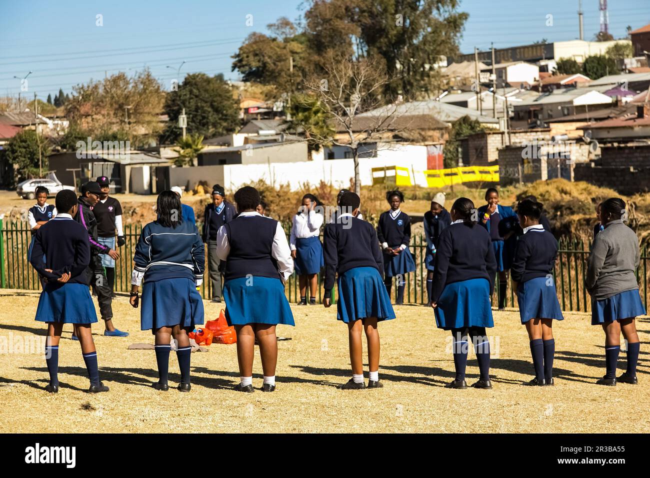 Diverse African high school pupils playing physical games on the sports ...