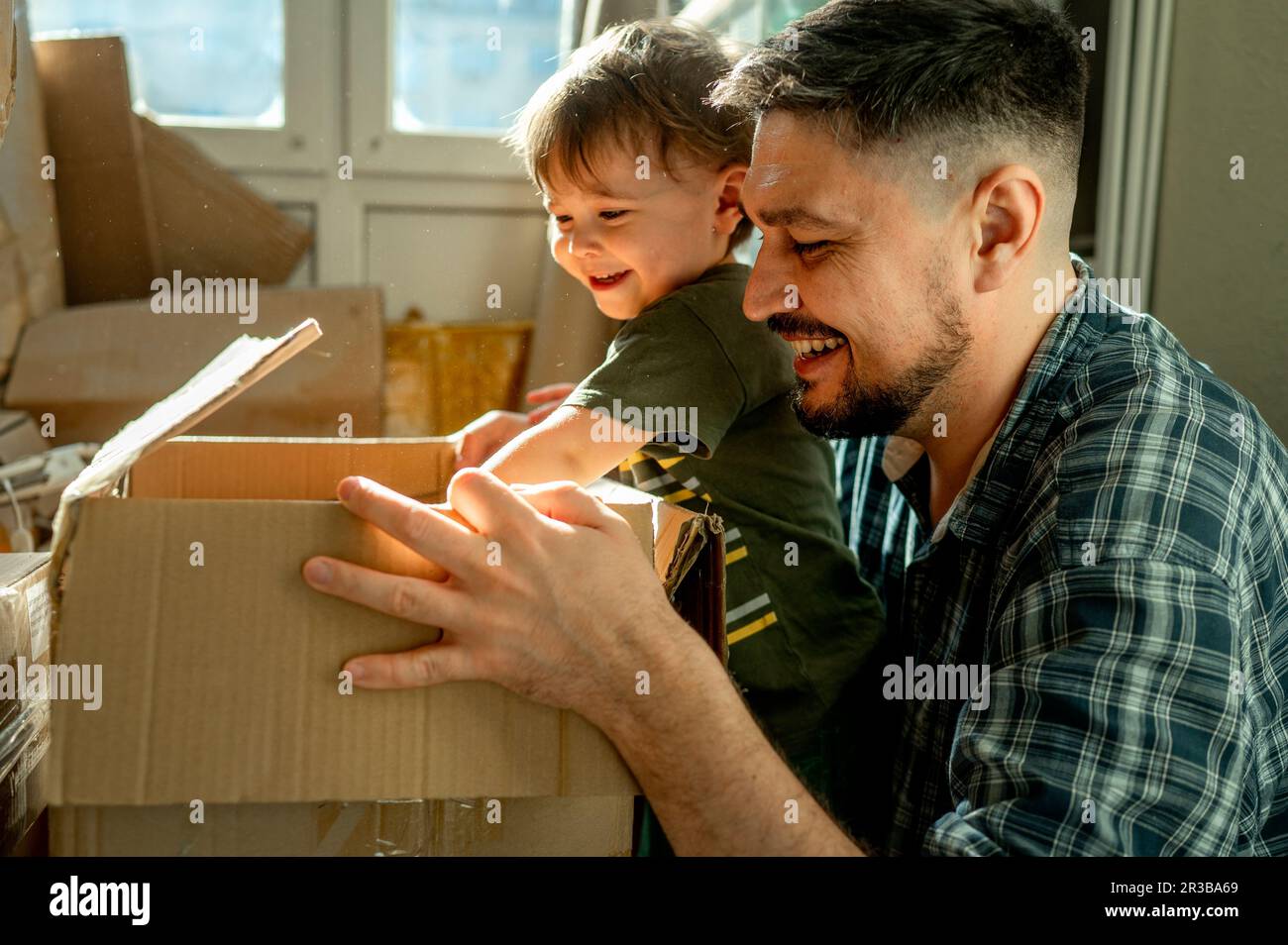 Father and son packing cardboard boxes at home Stock Photo - Alamy
