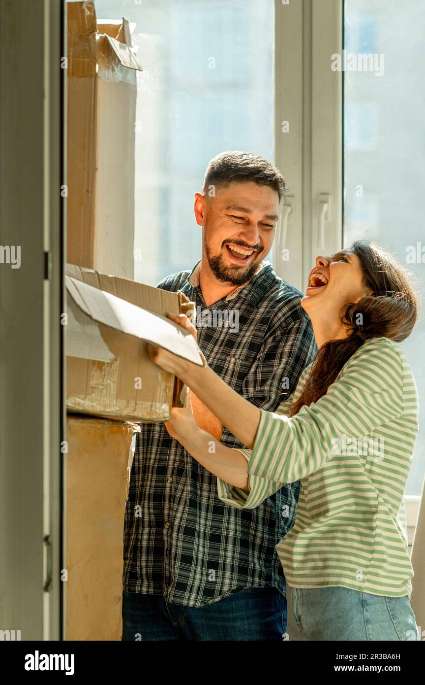 Man woman standing boxes hi-res stock photography and images - Alamy