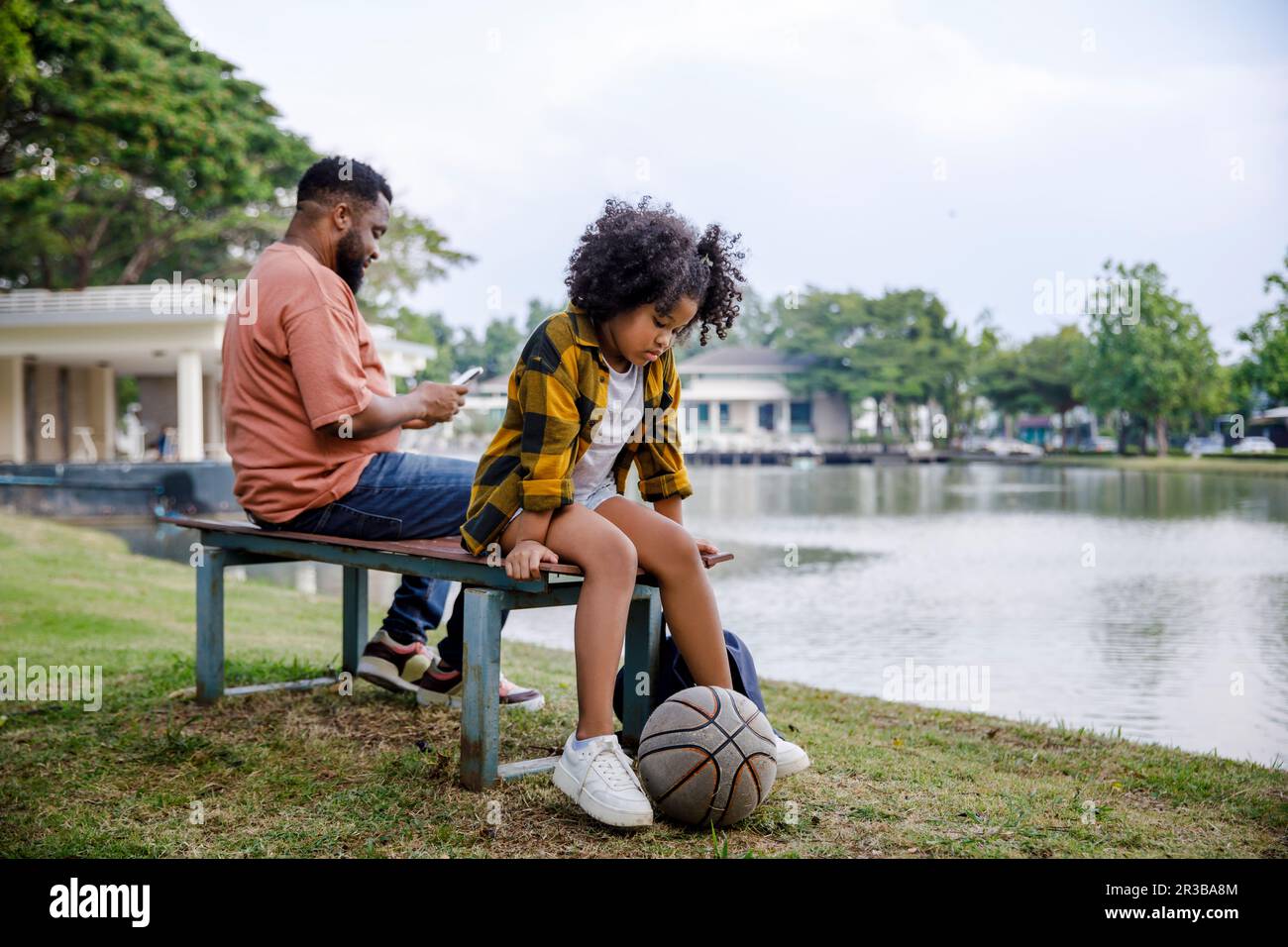 Girl sitting on basketball hi-res stock photography and images - Alamy