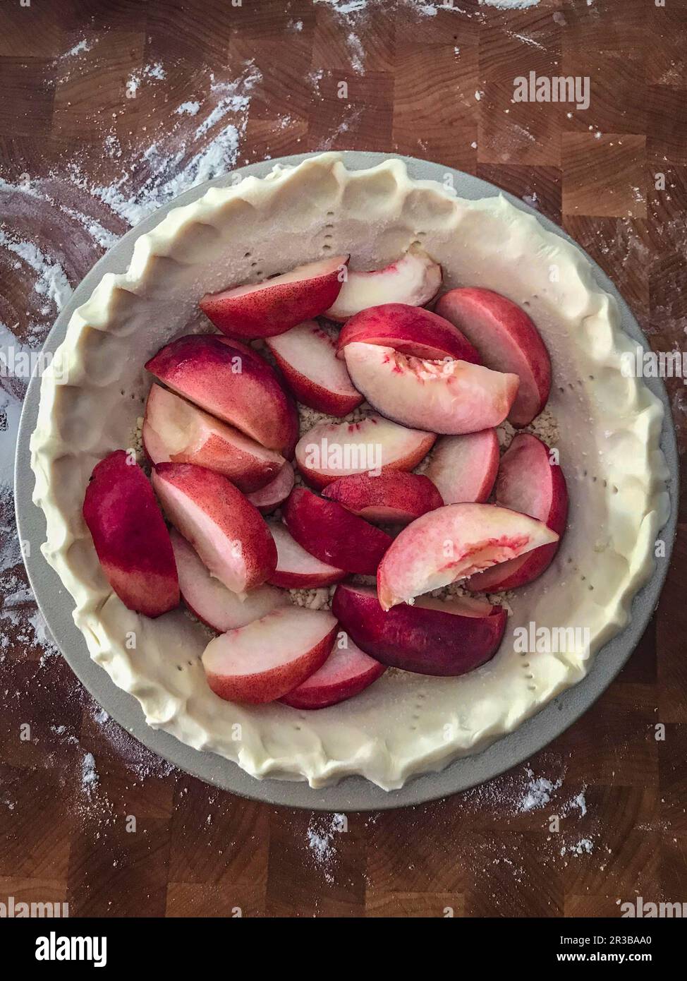 An unbaked peach pie Stock Photo - Alamy