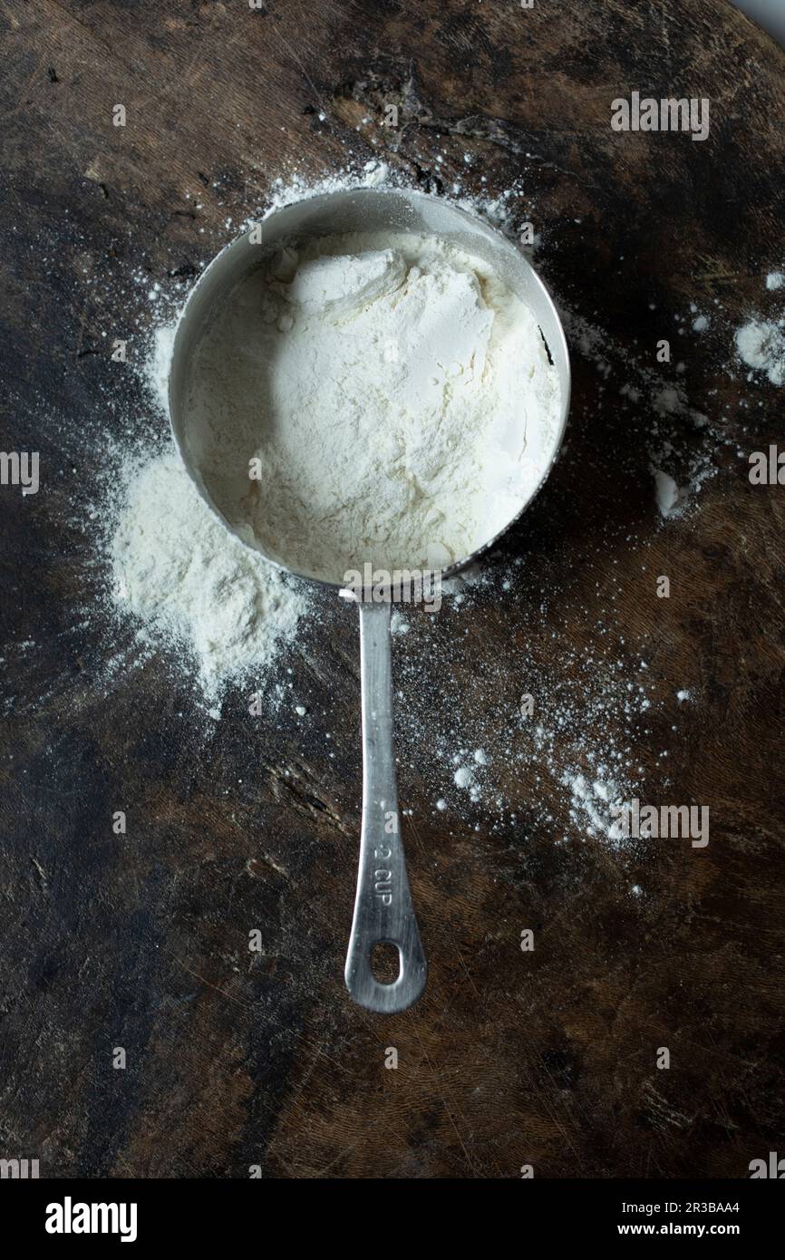 Flour in a measuring cup Stock Photo - Alamy