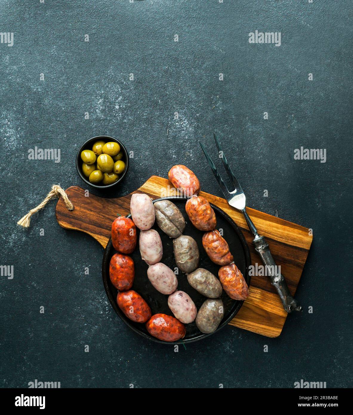 Spanish sausages on the cutting board (butifarra blanca, chorizo ...