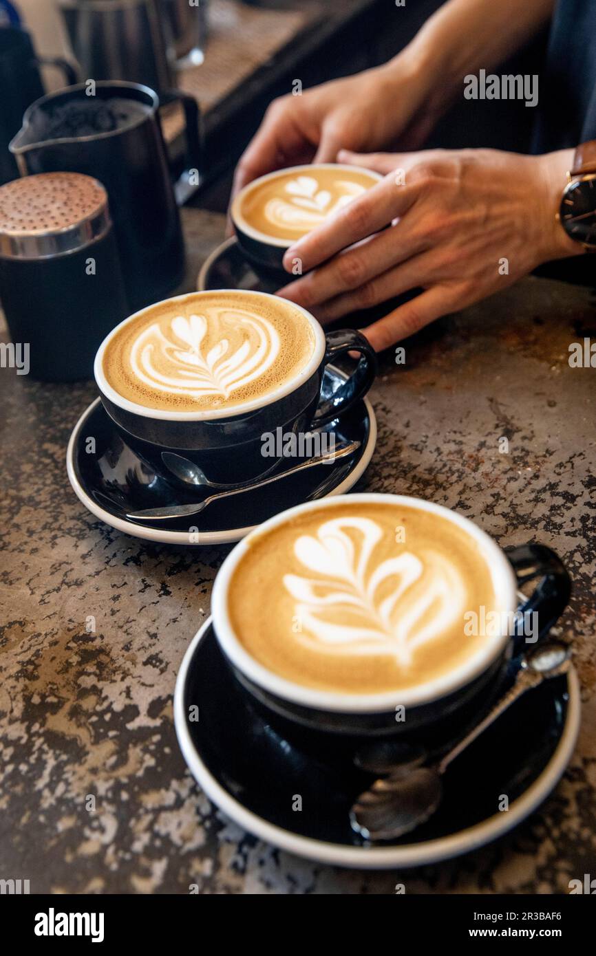 Cappuccinos with milk foam patterns (latte art Stock Photo - Alamy