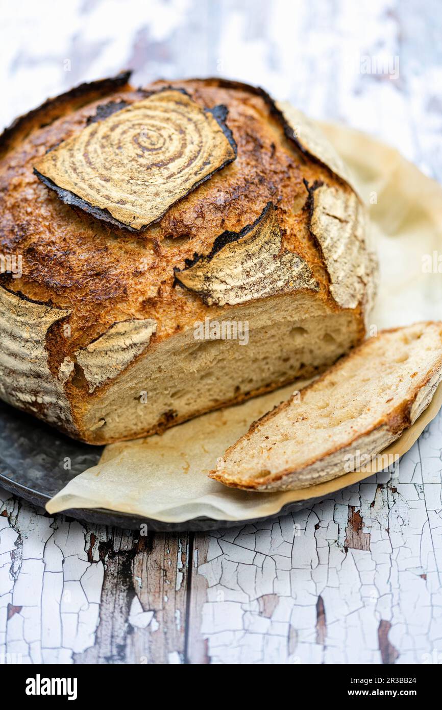 Close up on loaf of sourdough bread with end sliced to show interior ...