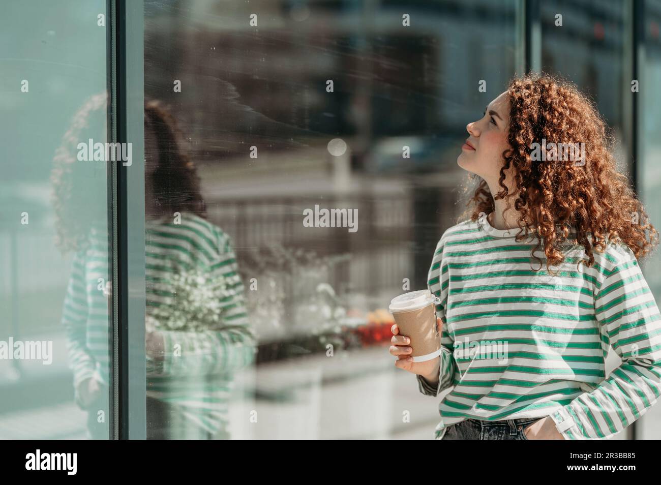 Woman looking glass hi-res stock photography and images - Alamy