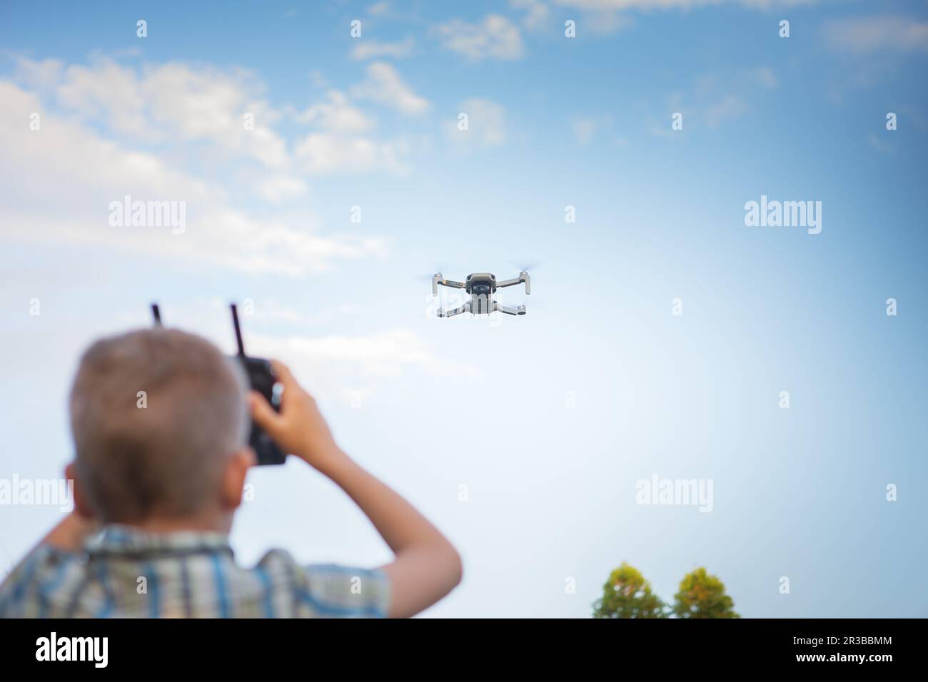 Kid flying drone. Boy operate drones. Child Operating Quadcopter ...