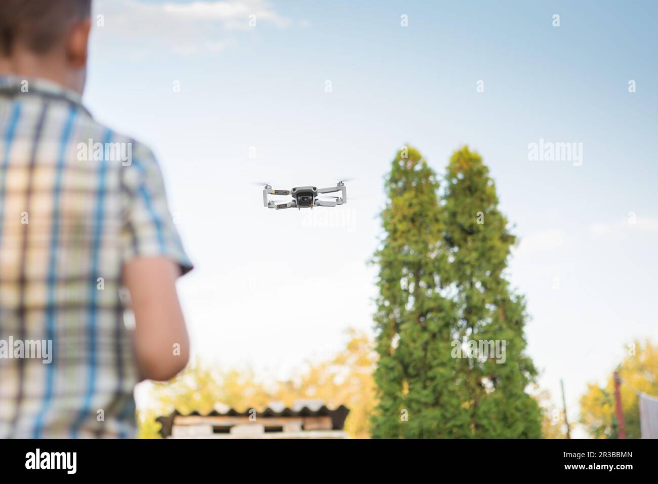 Kid flying drone. Boy operate drones. Child Operating Quadcopter ...