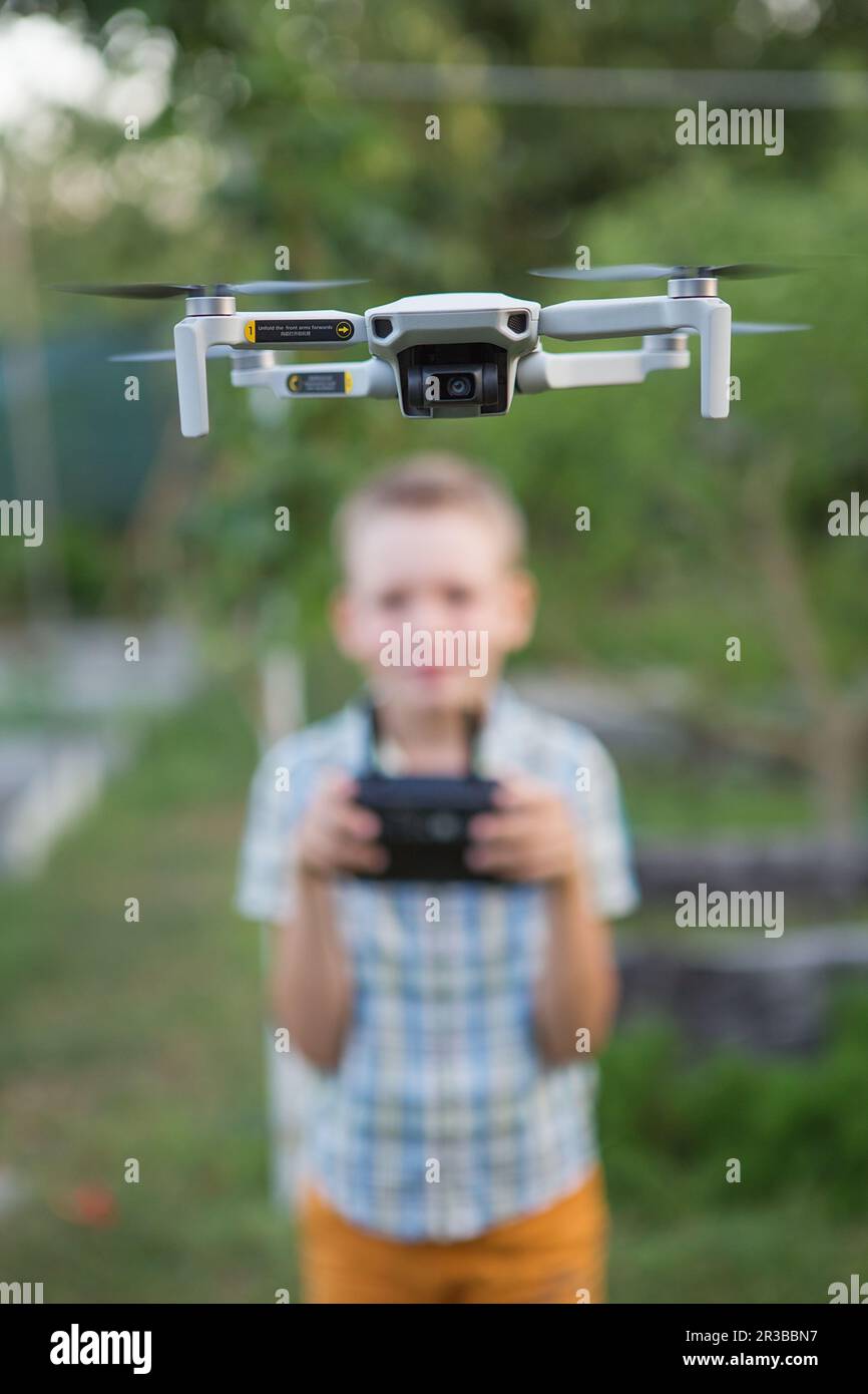 Kid flying drone. Boy operate drones. Child Operating Quadcopter ...