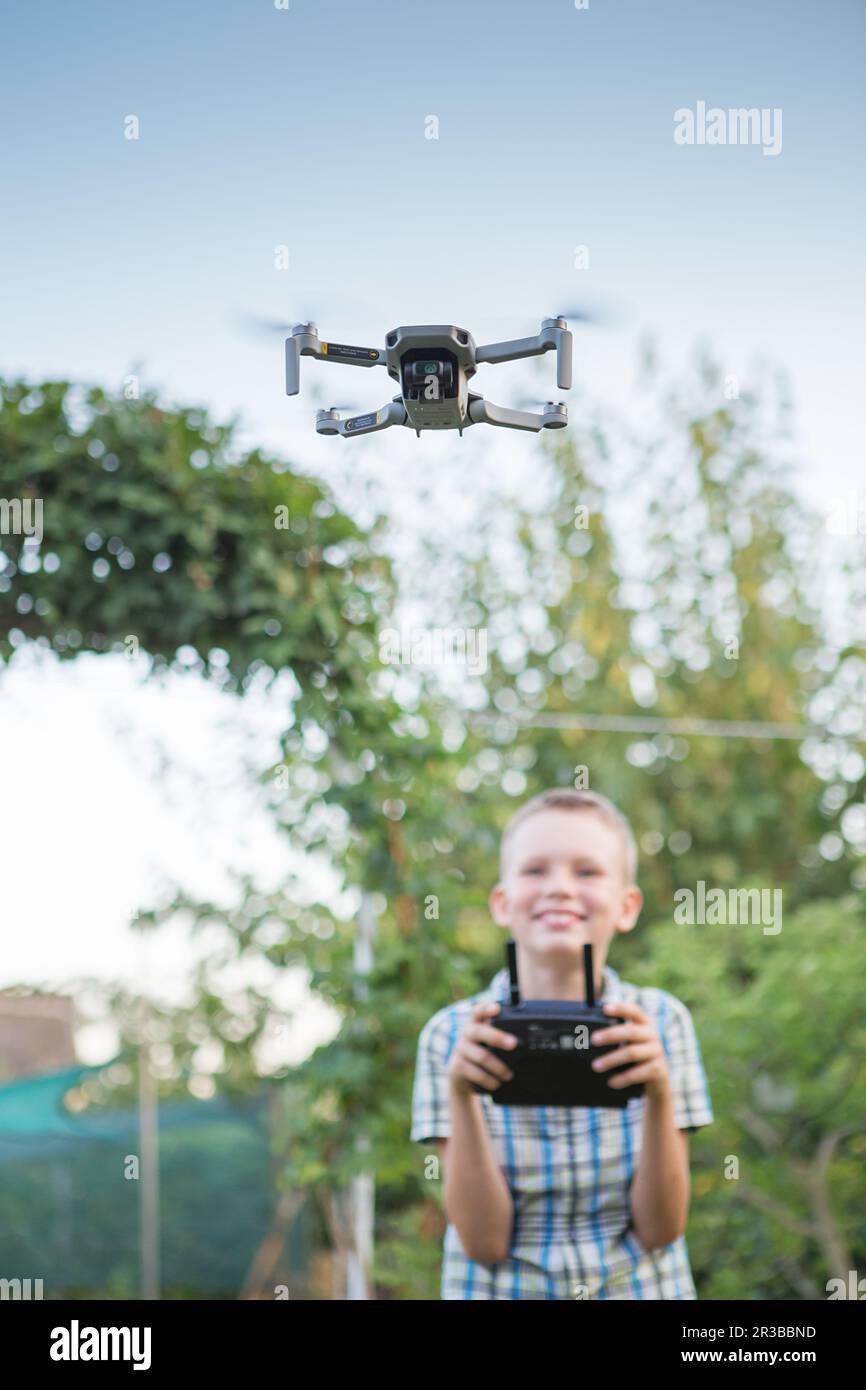 Kid flying drone. Boy operate drones. Child Operating Quadcopter ...