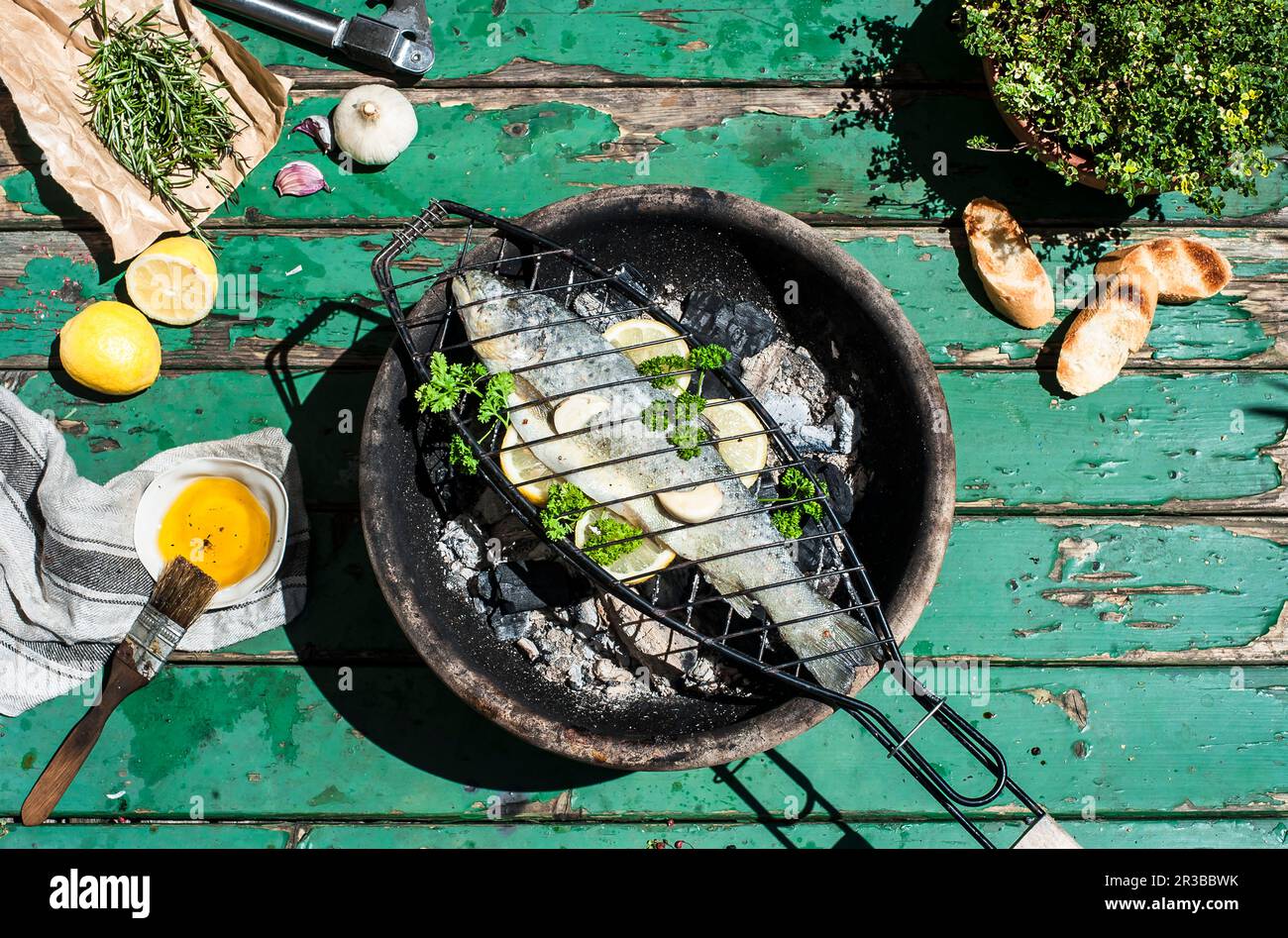 Fish cooking on barbecue grill Stock Photo - Alamy