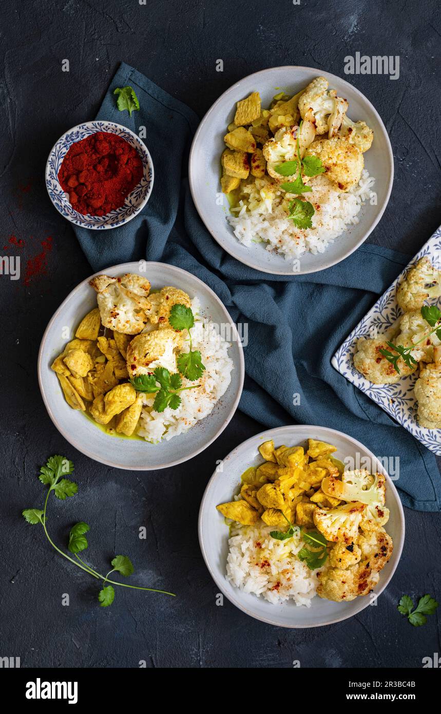 Coconut curry chicken with roasted cauliflower and rice Stock Photo - Alamy