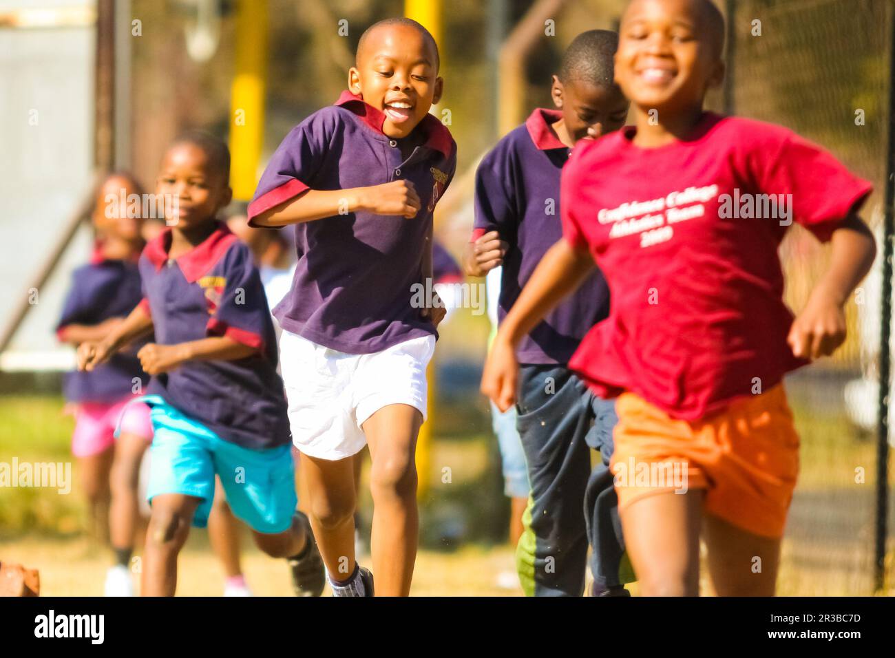 Diverse African Primary School children doing physical exercise PT ...