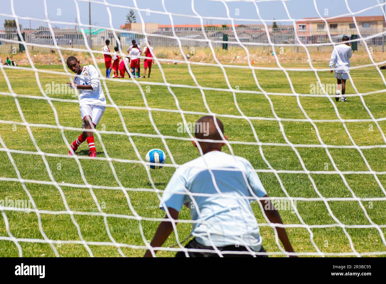 Diverse children playing soccer football at school Stock Photo - Alamy