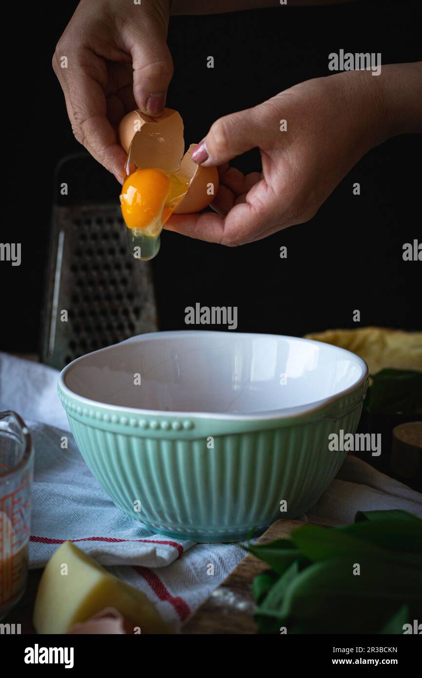 Adding eggs in the filling Stock Photo - Alamy