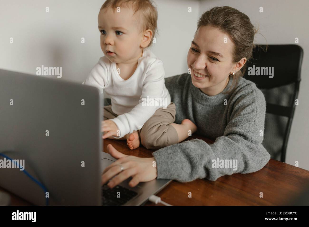 Two boys using laptop home hi-res stock photography and images - Alamy
