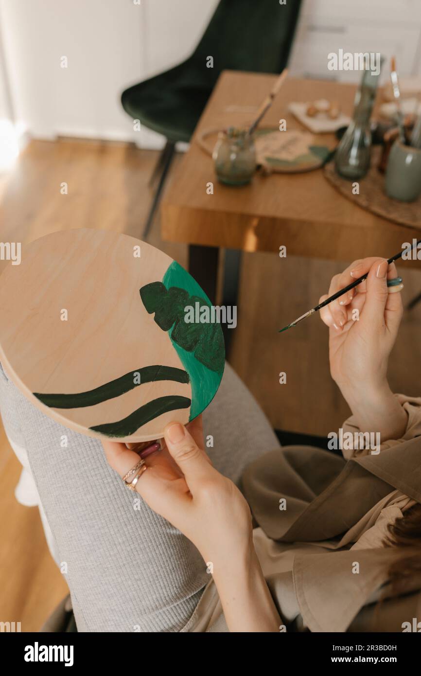 Woman sitting wooden table on hi-res stock photography and images - Alamy
