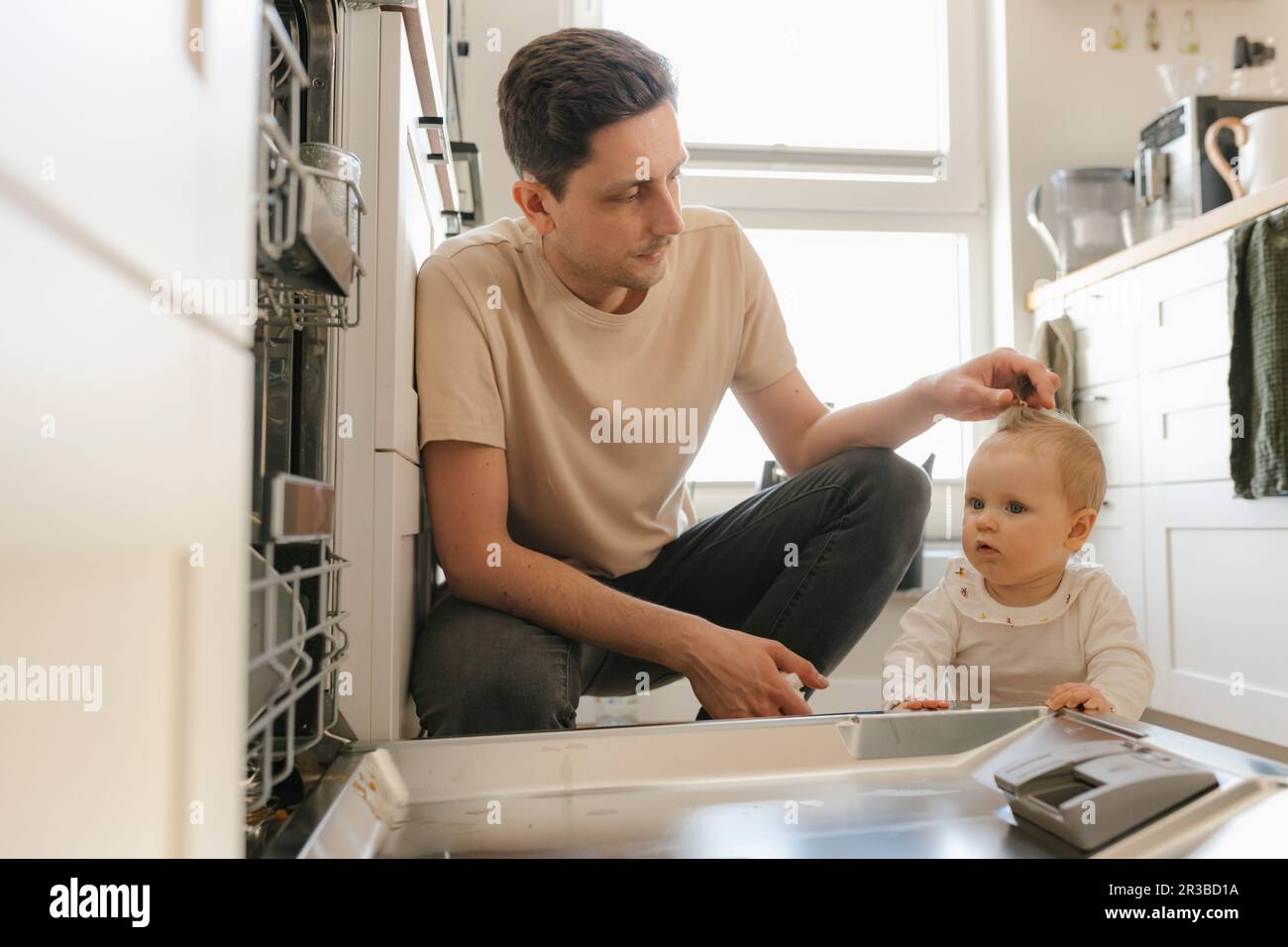 Girl loading dishwasher in kitchen hi-res stock photography and images ...