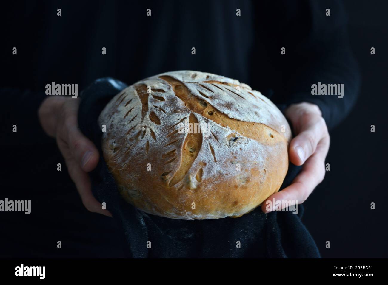Holding a loaf of bread in his hands hi-res stock photography and ...