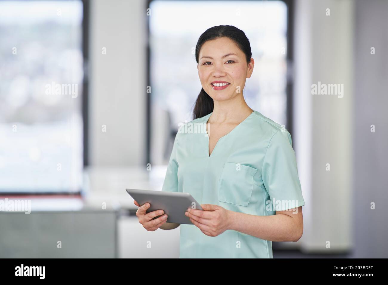 Smiling nurse holding medicine hi-res stock photography and images - Alamy