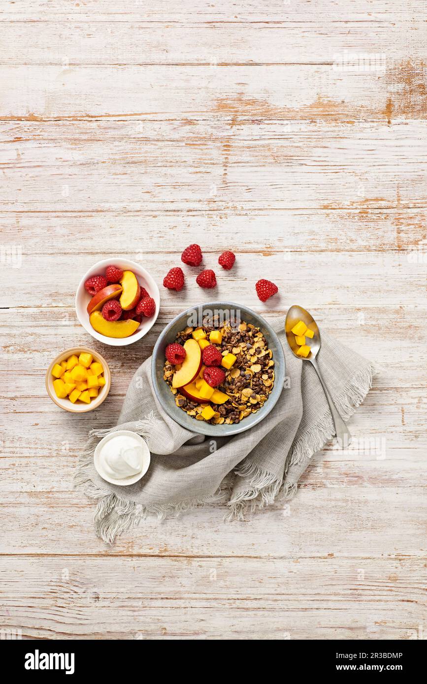 Museli with Raspberries Peaches and Chocolate Pieces Stock Photo - Alamy