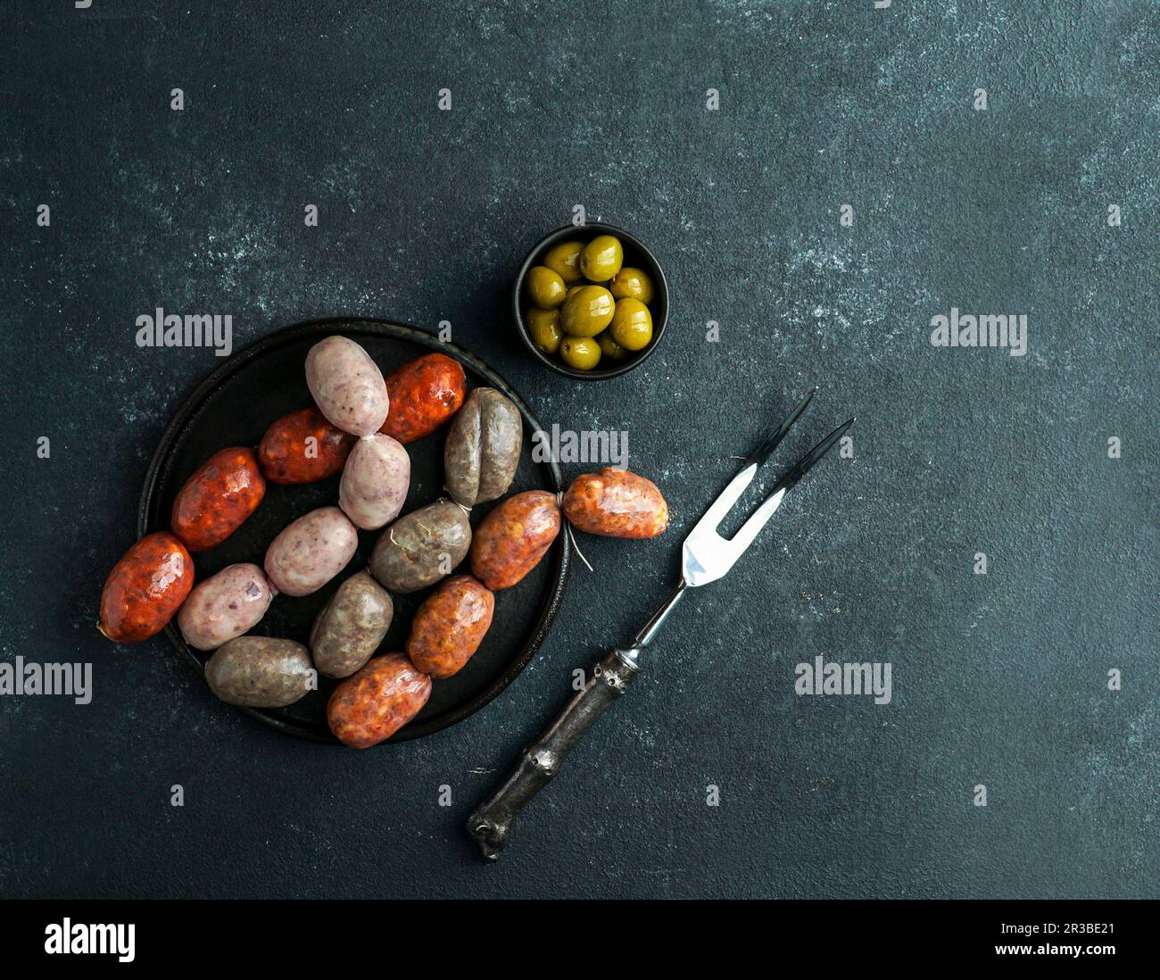 Spanish sausages on the cutting board - butifarra blanca, chorizo ...